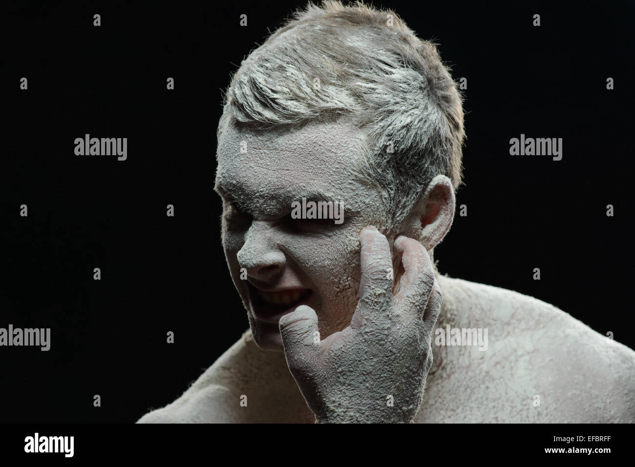 Handsome man covered with powder itching Stock Photo - Alamy