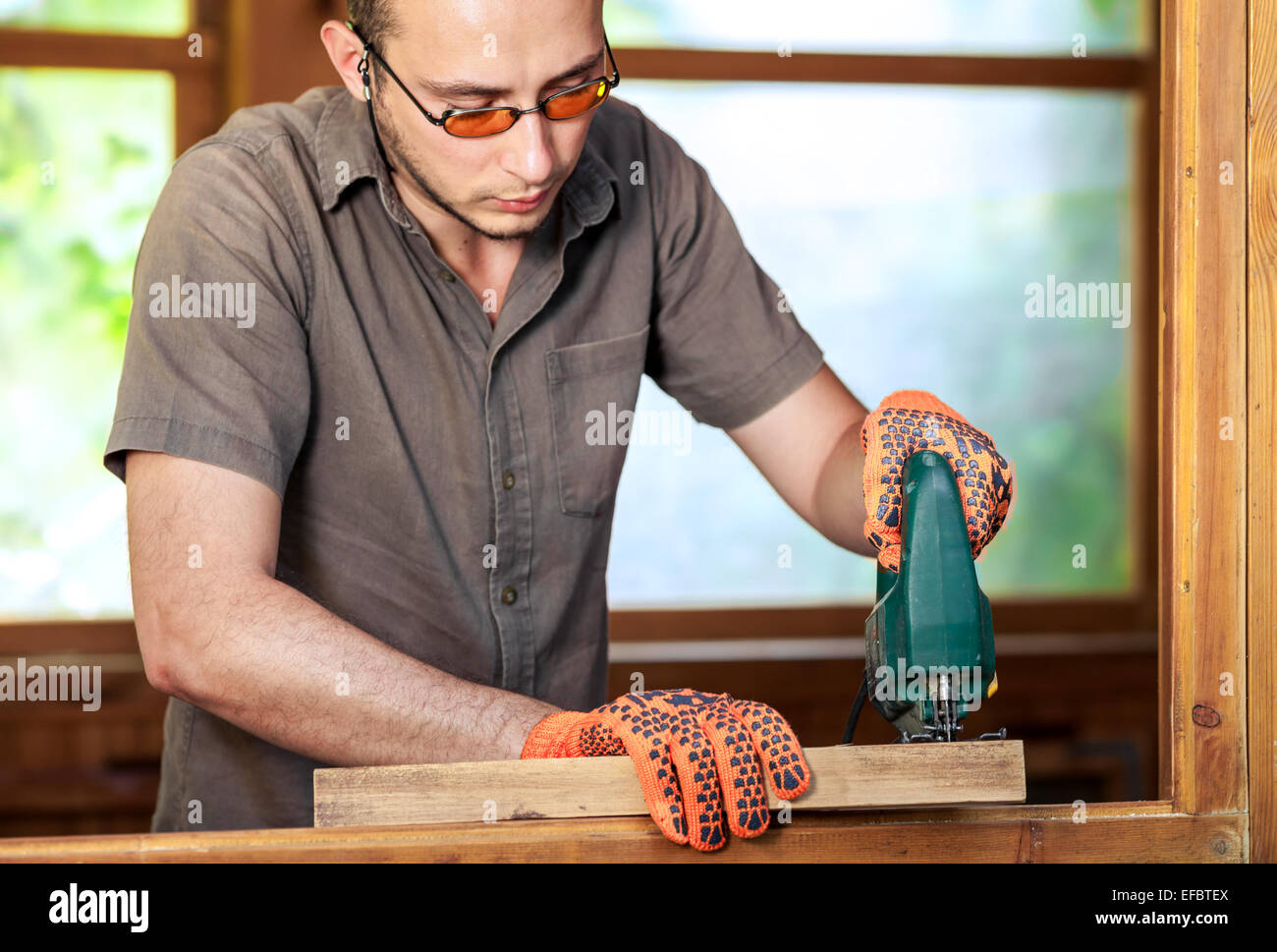 Young man working with wood Stock Photo - Alamy