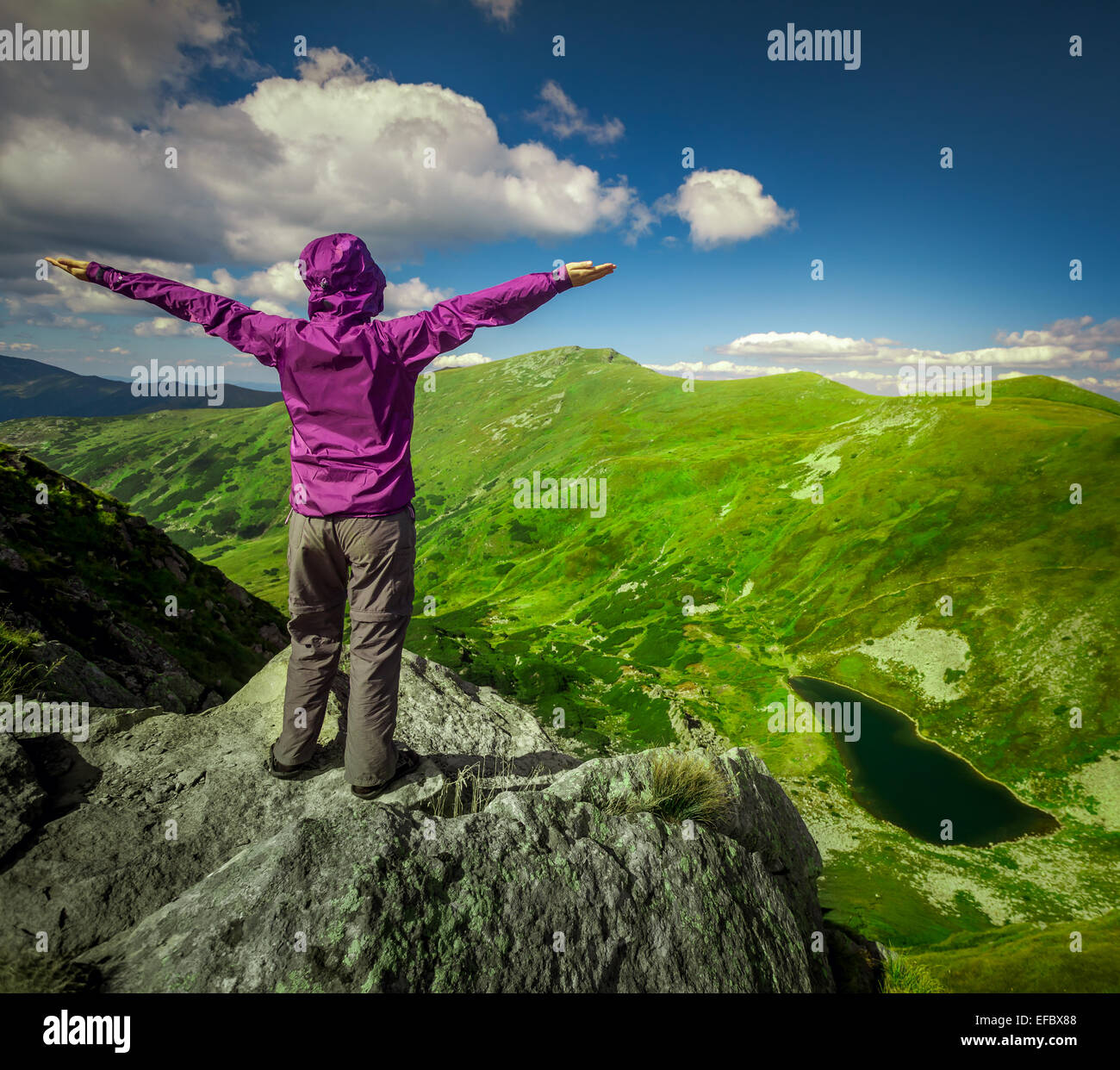 Woman on top of a mountain Stock Photo - Alamy