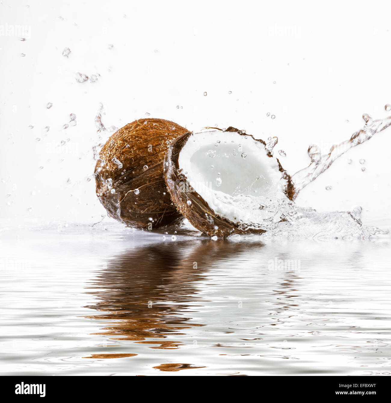 Cracked coconut splashing milk hi-res stock photography and images - Alamy
