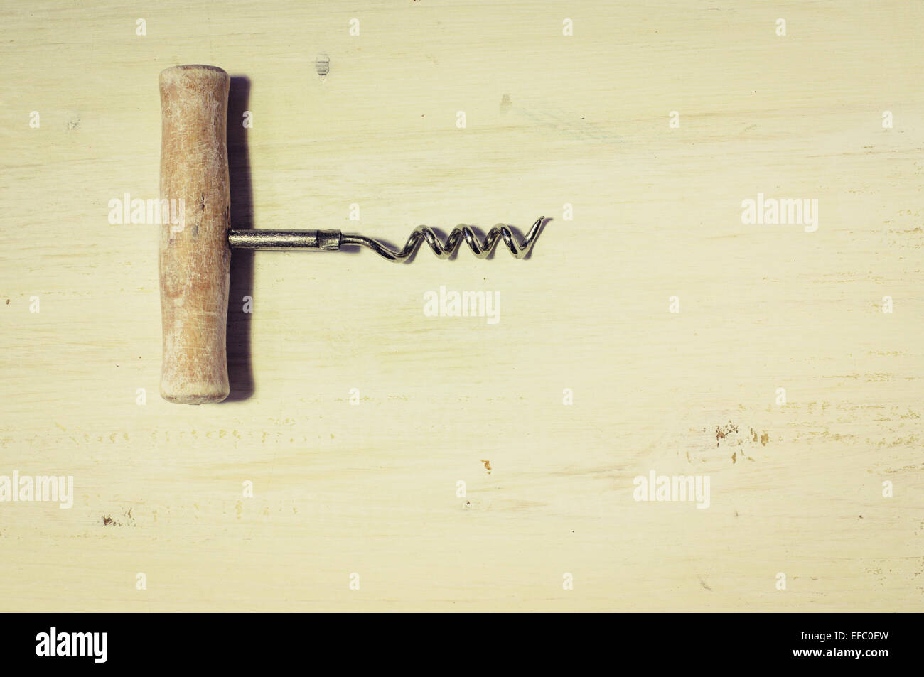 Vintage corkscrew on the old board for background Stock Photo - Alamy