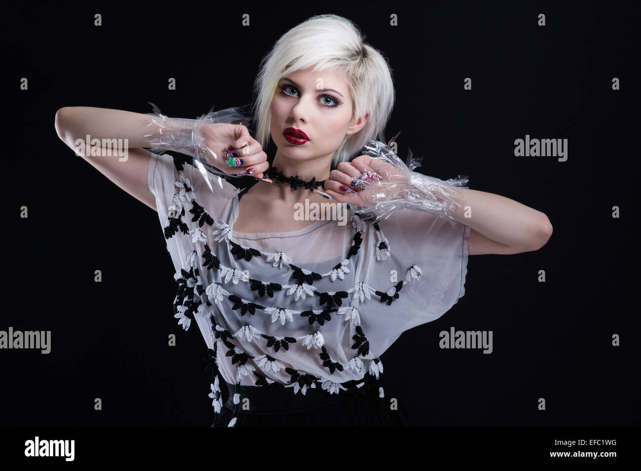 Japanese street fashion girl holding her neckless Stock Photo - Alamy