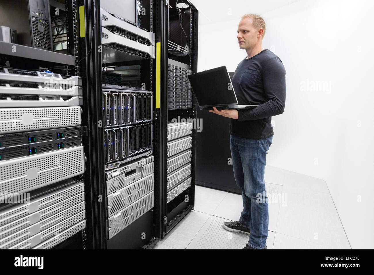 It consultant monitor servers in data center Stock Photo - Alamy