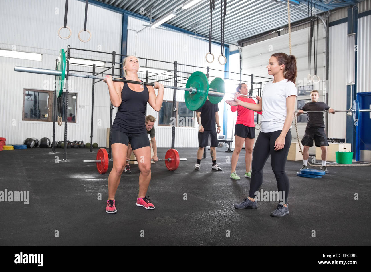Workout team training at fitness center Stock Photo - Alamy