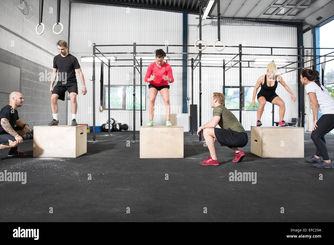 Crossfit group trains box jump Stock Photo - Alamy