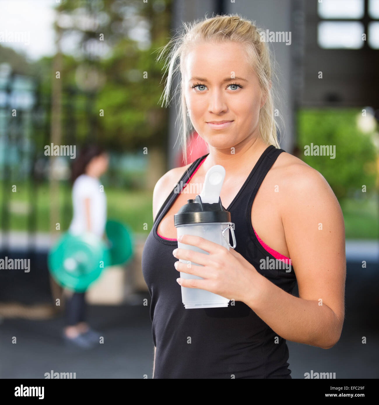 Woman rest and drinking water after workout Stock Photo - Alamy