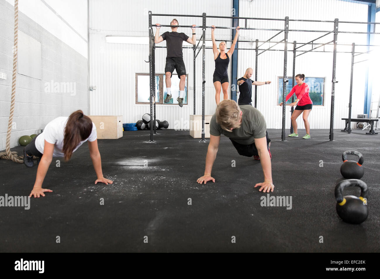 Workout group trains exercises at fitness gym Stock Photo - Alamy