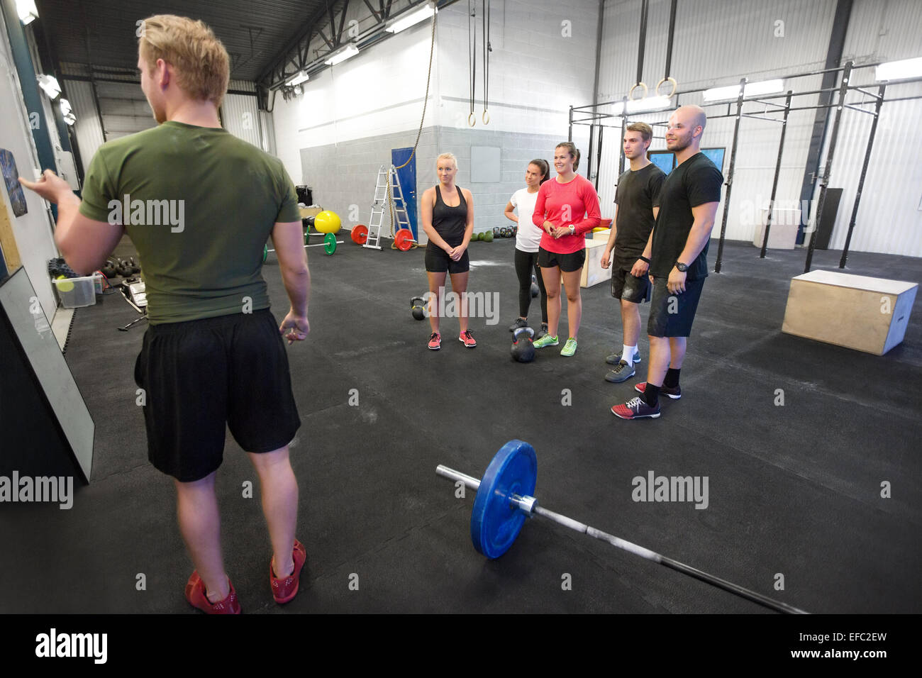Instructor teach his fitness team at the gym Stock Photo - Alamy