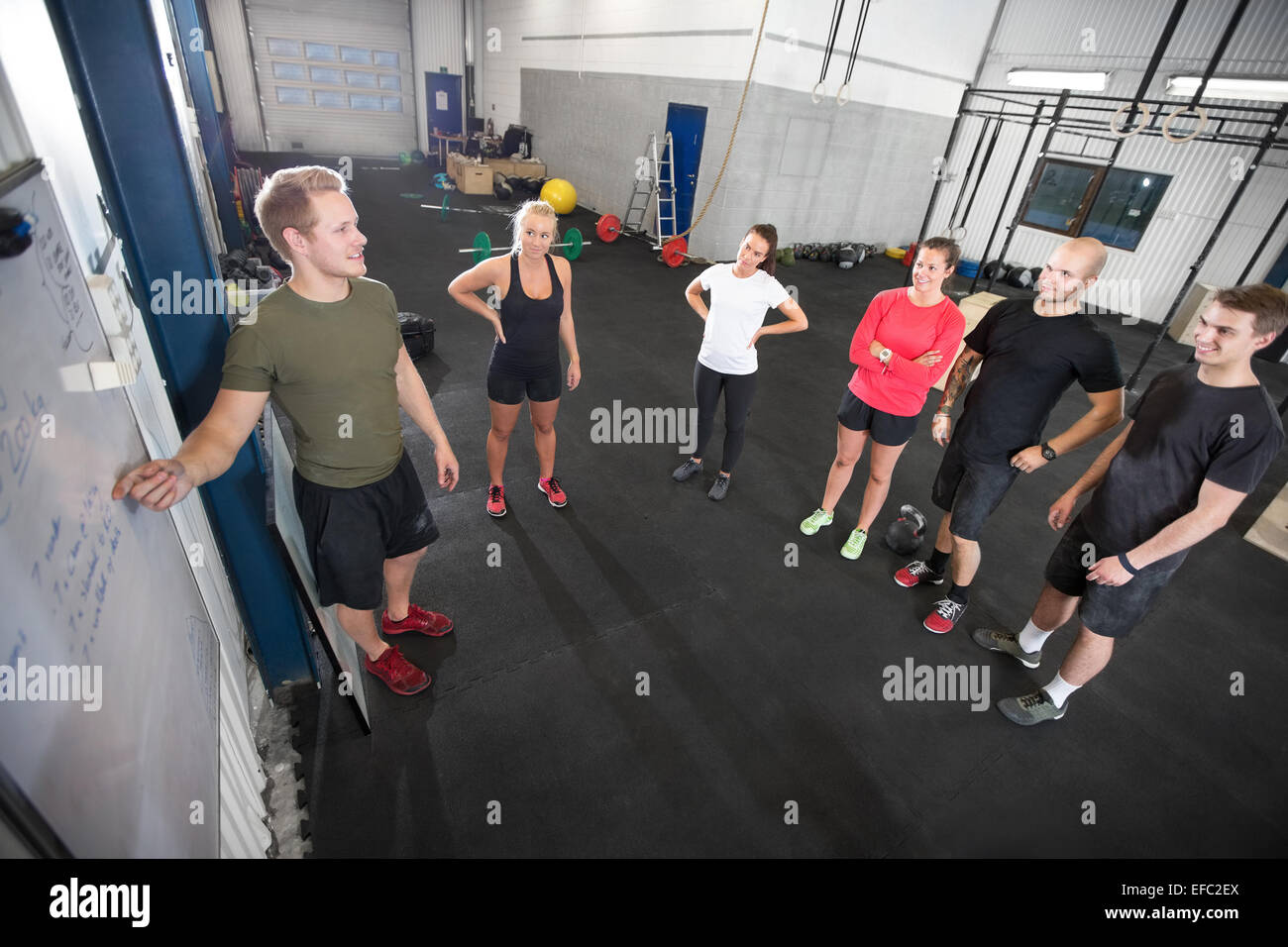 Personal trainer teaches his fitness workout team Stock Photo - Alamy