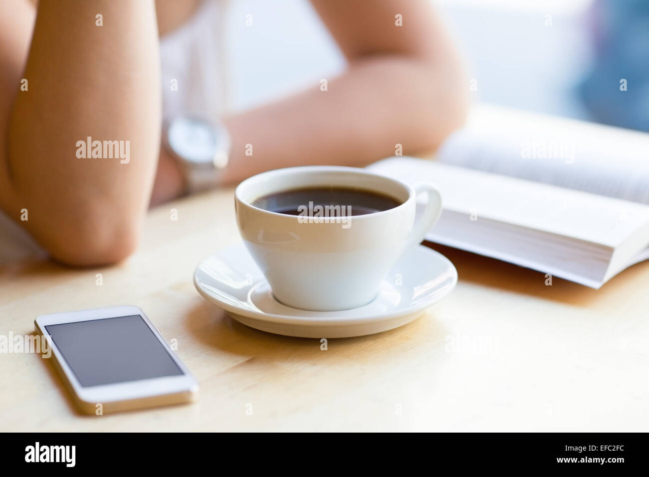 Girl reading book and drinking coffee at cafe Stock Photo - Alamy