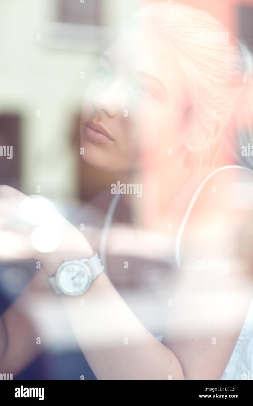 Beautiful teenage girl behind window Stock Photo - Alamy