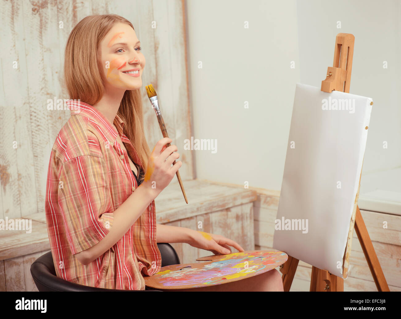 Young beautiful woman creating a masterpiece Stock Photo - Alamy