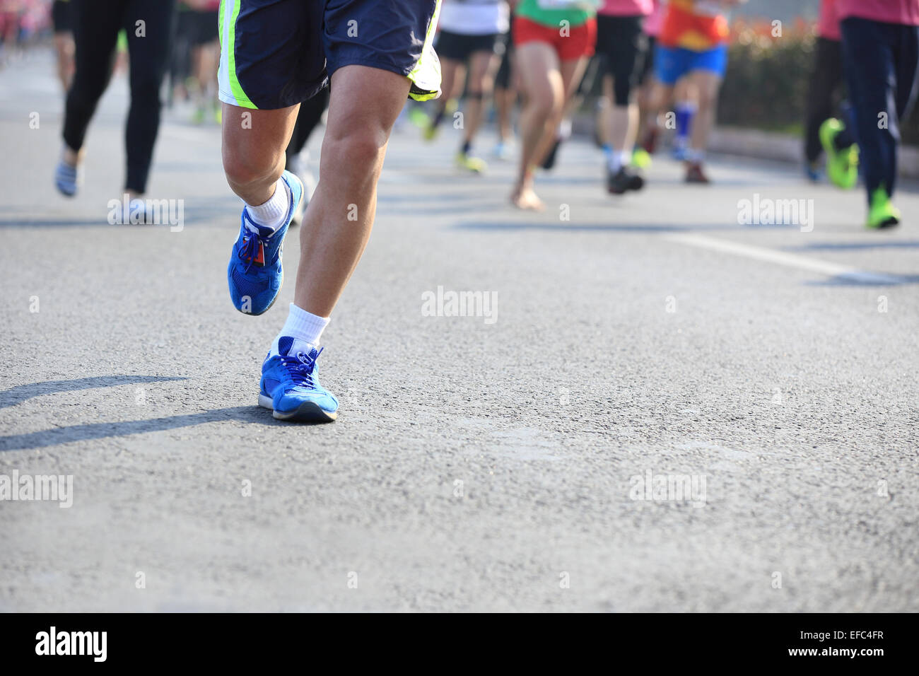 marathon runners runnning on city road Stock Photo - Alamy