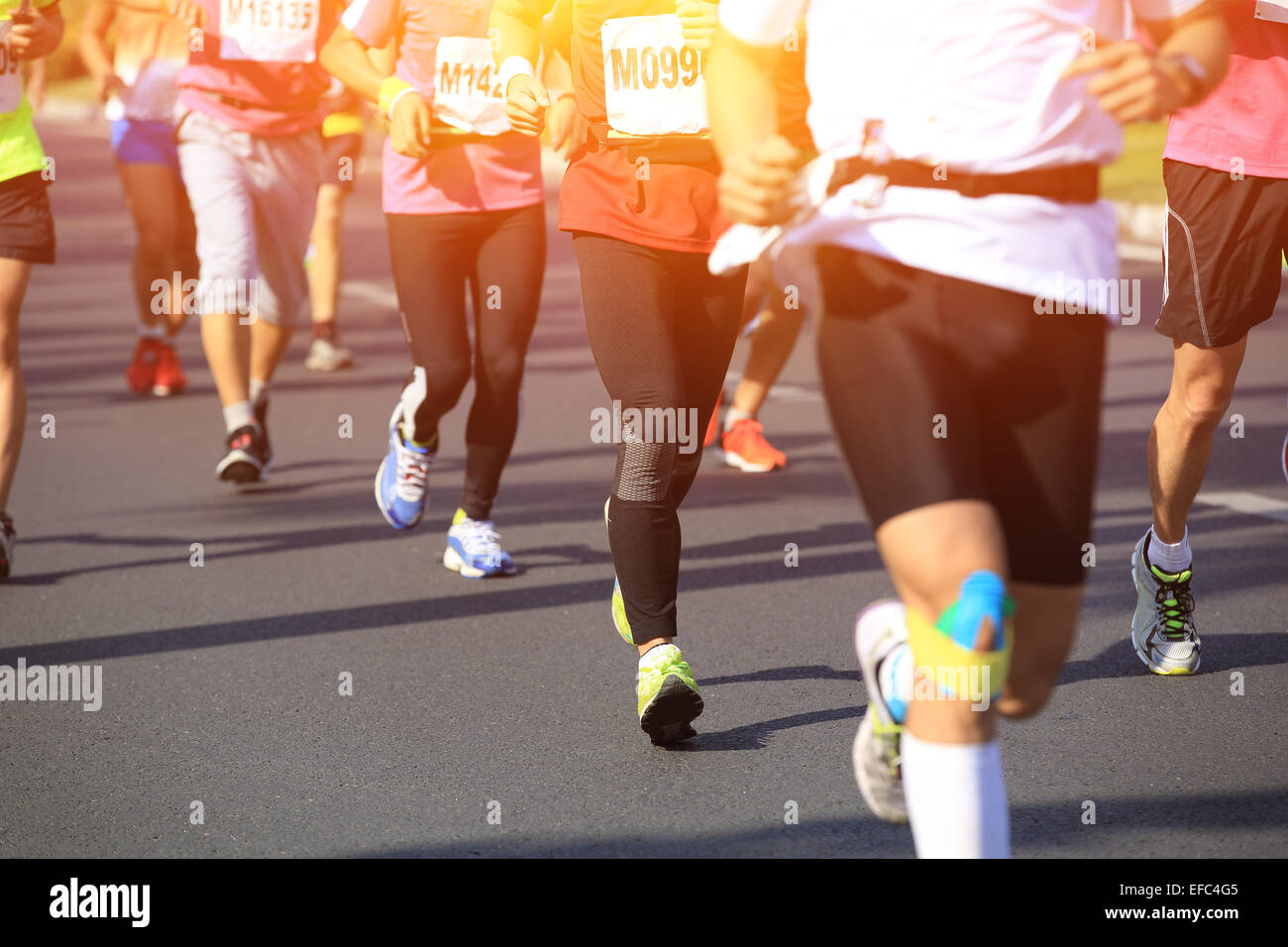 marathon runners runnning on city road Stock Photo - Alamy