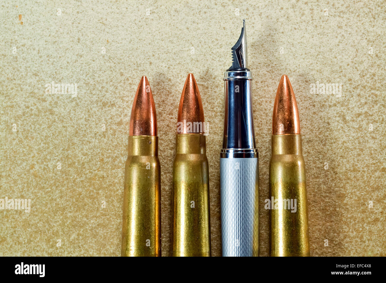 Pen and three bullets arranged vertically on vintage background Stock ...
