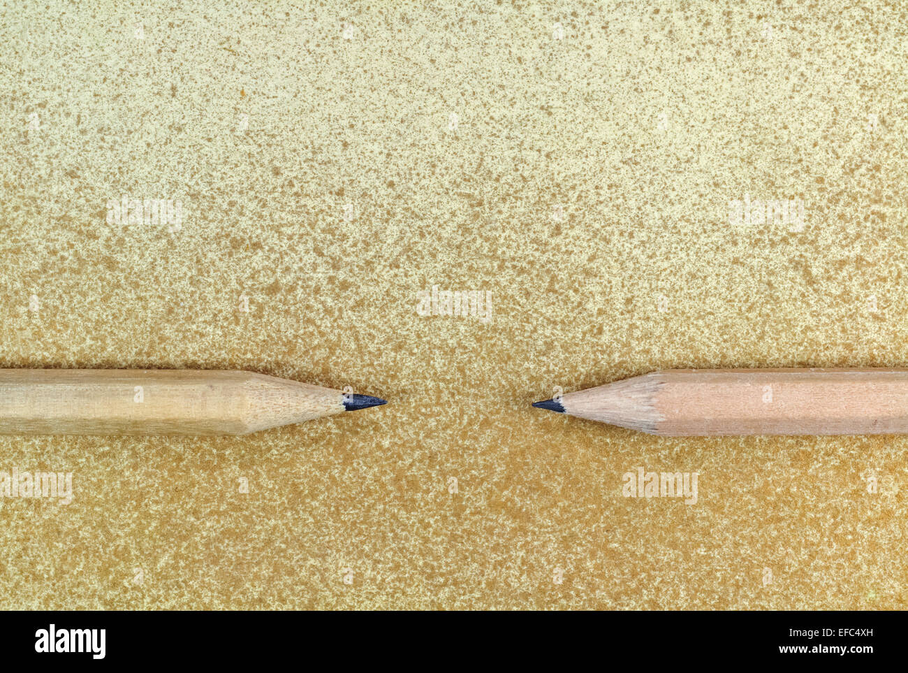 Two pencils arranged horizontally on yellow grunge background Stock ...