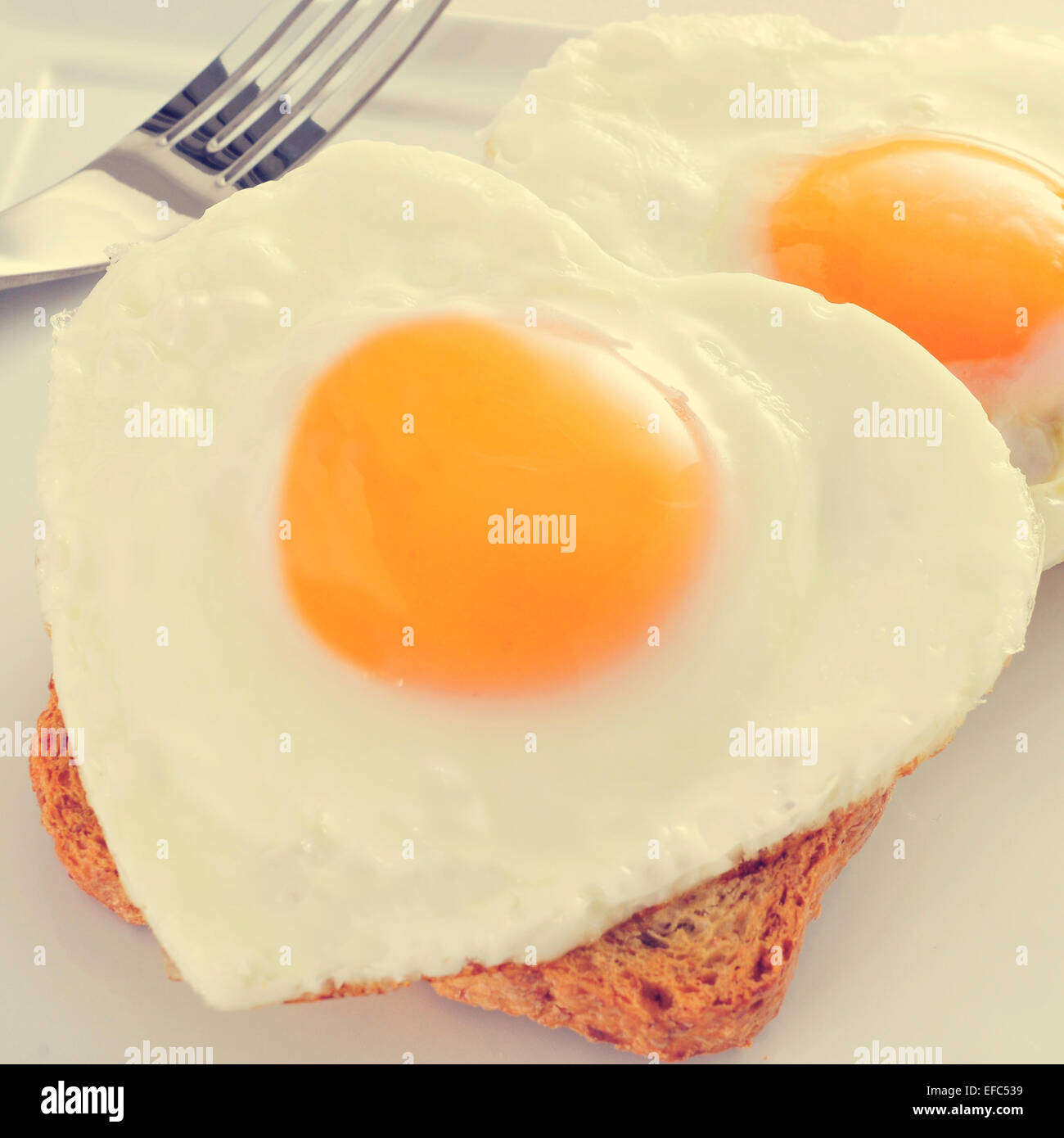 closeup of some heart-shaped fried eggs served on toasts, with a filter effect Stock Photo - Alamy