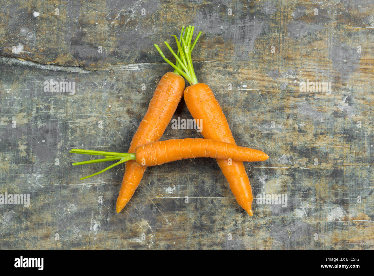 Carrots on old wooden table Stock Photo - Alamy
