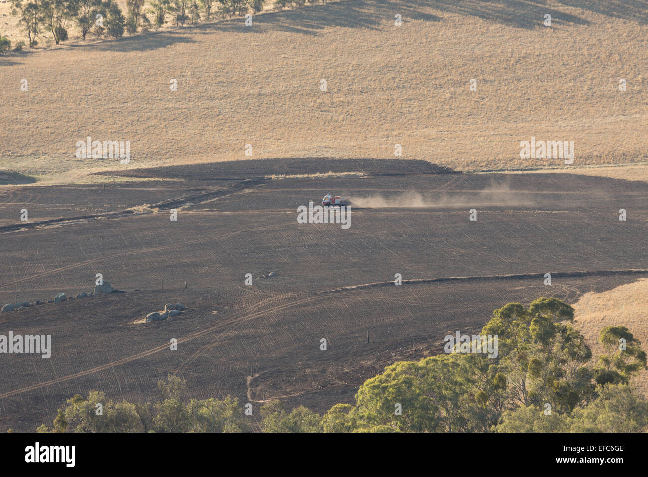A photograph of the aftermath of a bush fire on a dry Australian farm ...