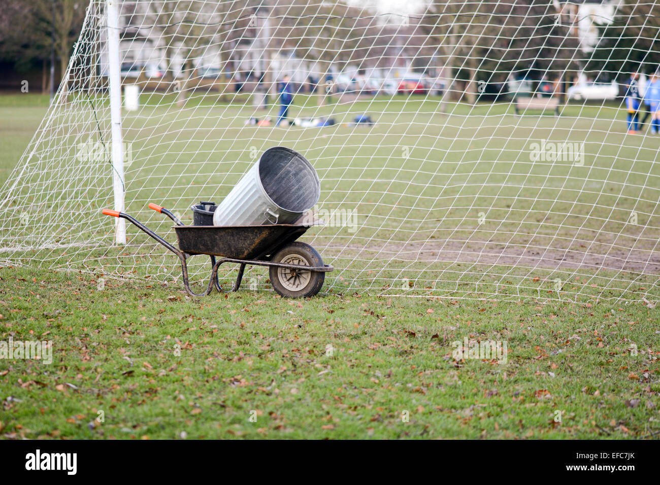 Wheelbarrow and bin behind football goal - used to carry football net ...