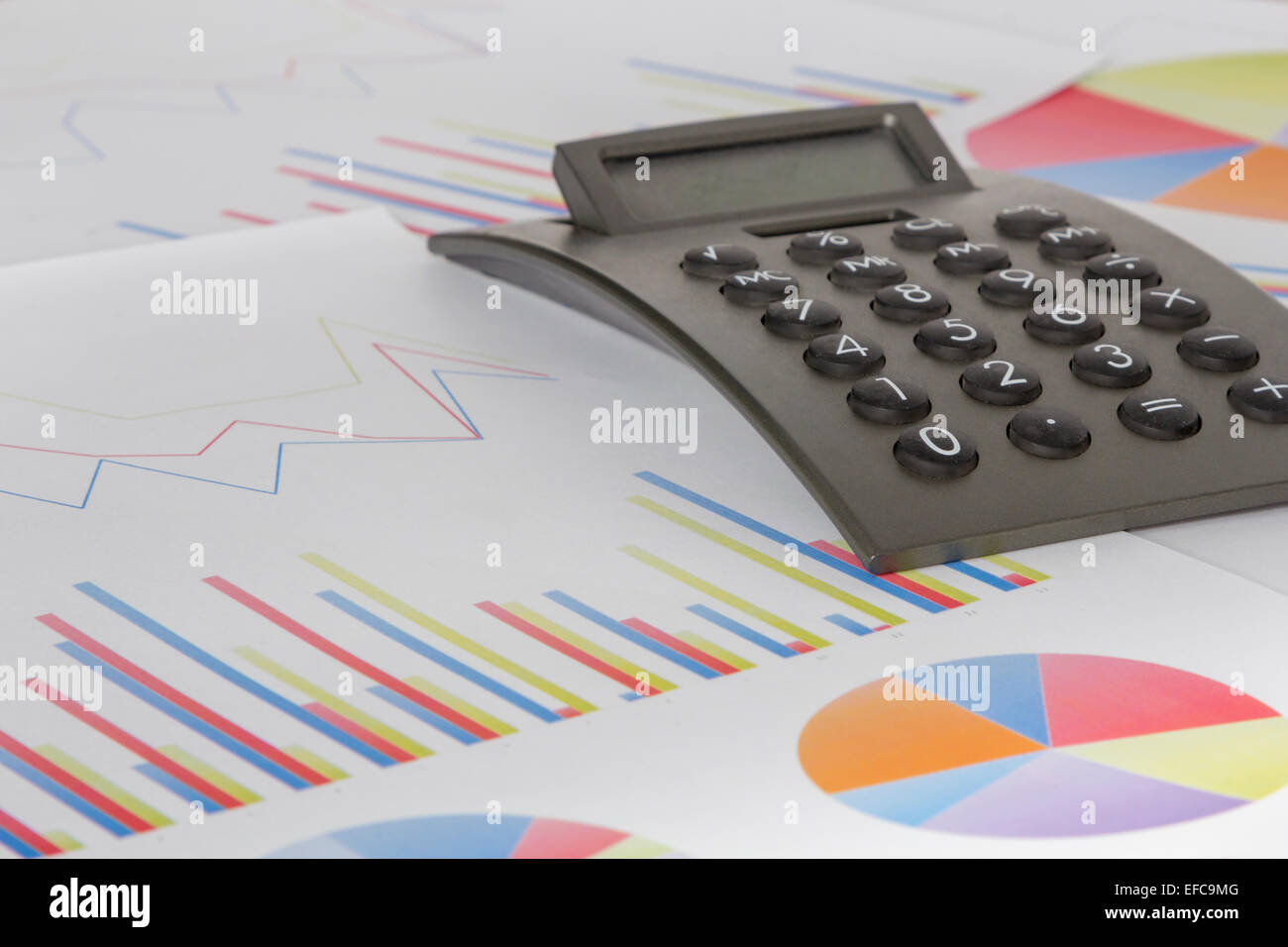 Calculator on a batch of colorful diagrams Stock Photo - Alamy