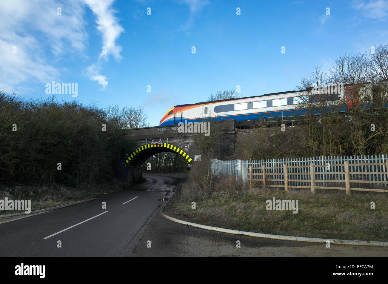 Train passing over a bridge on the rail line to the south of Corby ...