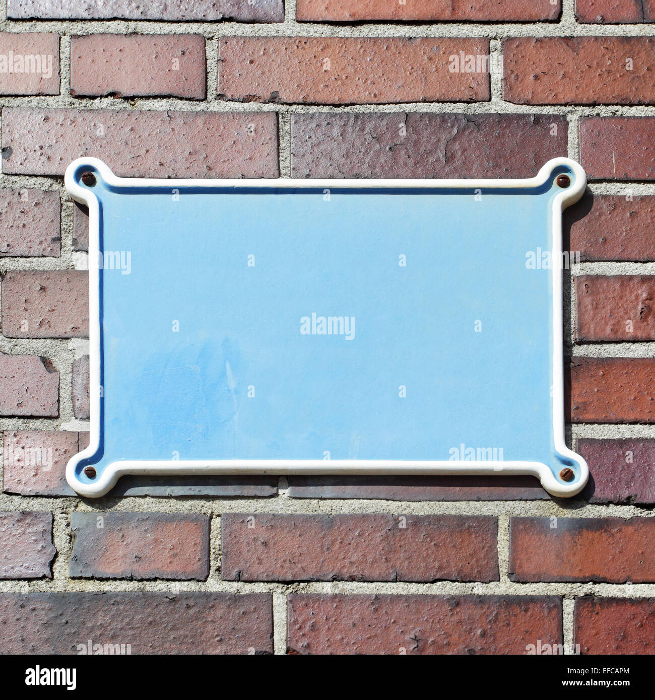 Blank sign on red brick wall Stock Photo - Alamy
