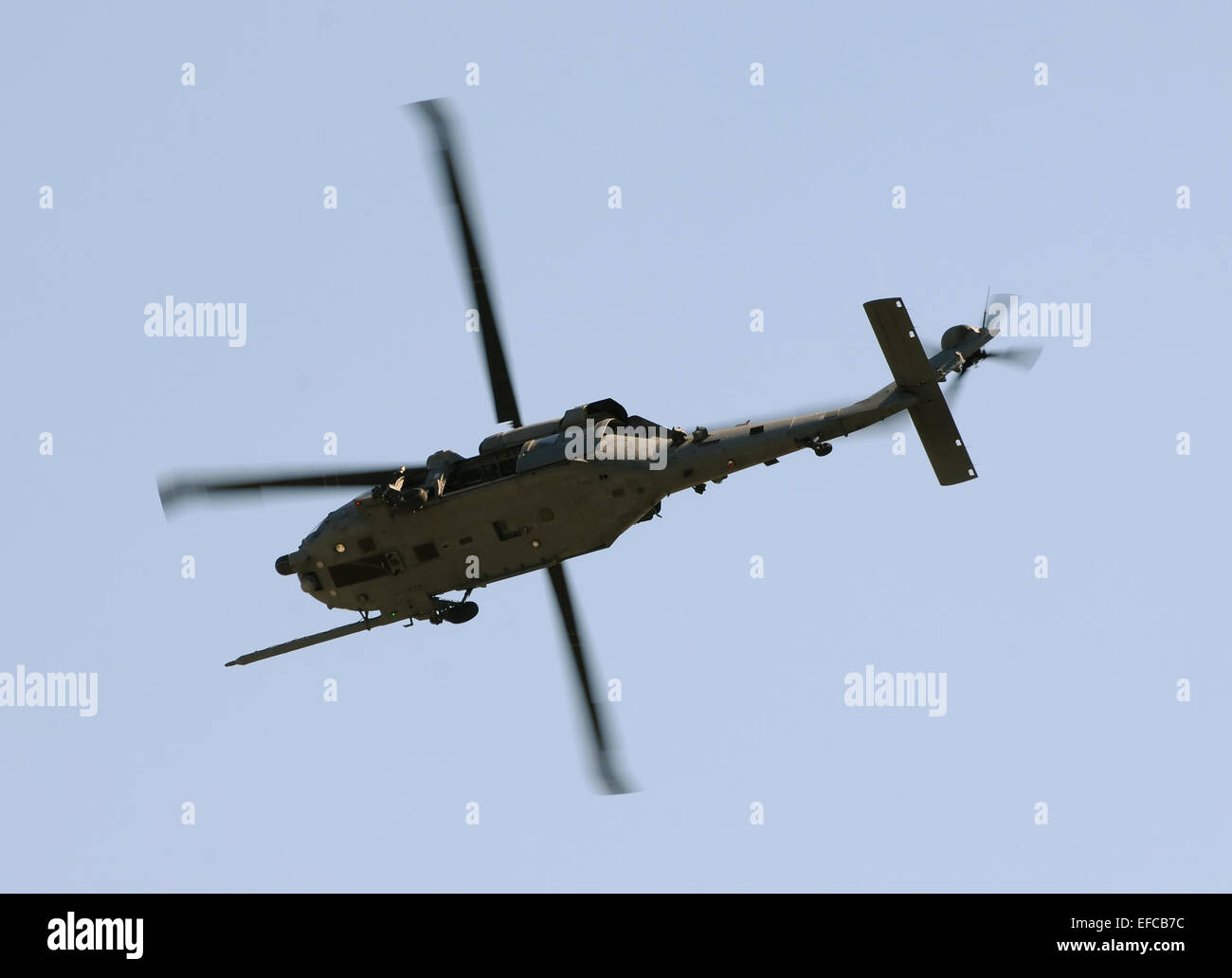 Modern military helicopter on a mission flying overhead Stock Photo - Alamy