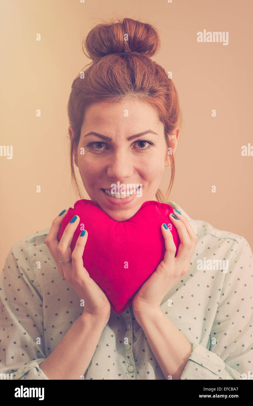 Young woman showing heart in hi-res stock photography and images - Alamy