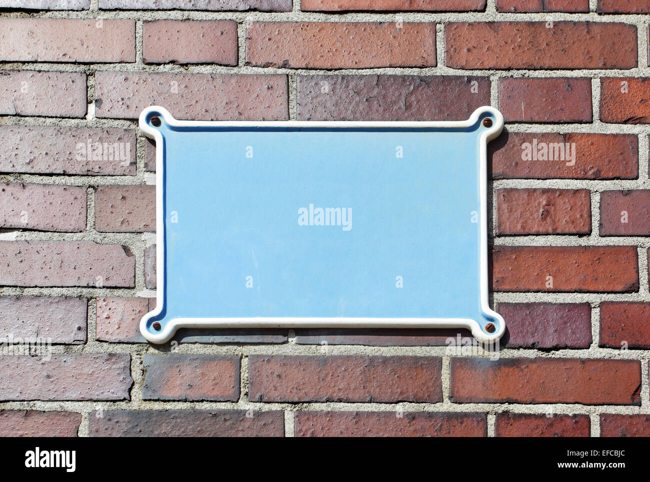 Blank sign on red brick wall Stock Photo - Alamy