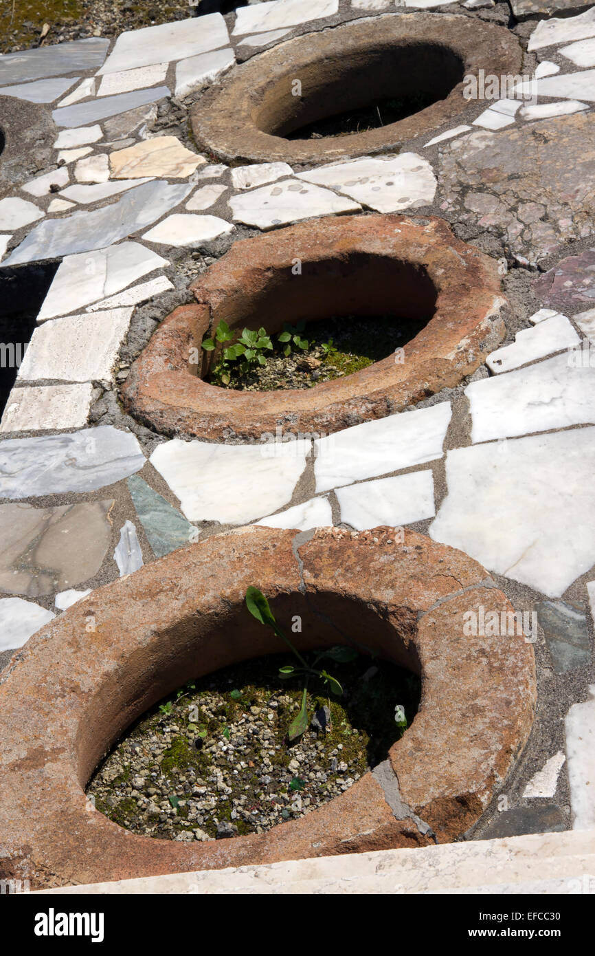 Round holes for storing wine or cooked food in the remains of a shop in ...