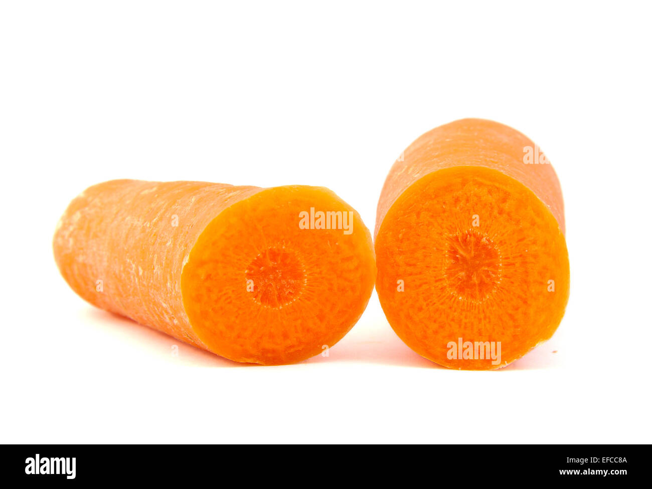 Two carrot halves on a white background Stock Photo - Alamy