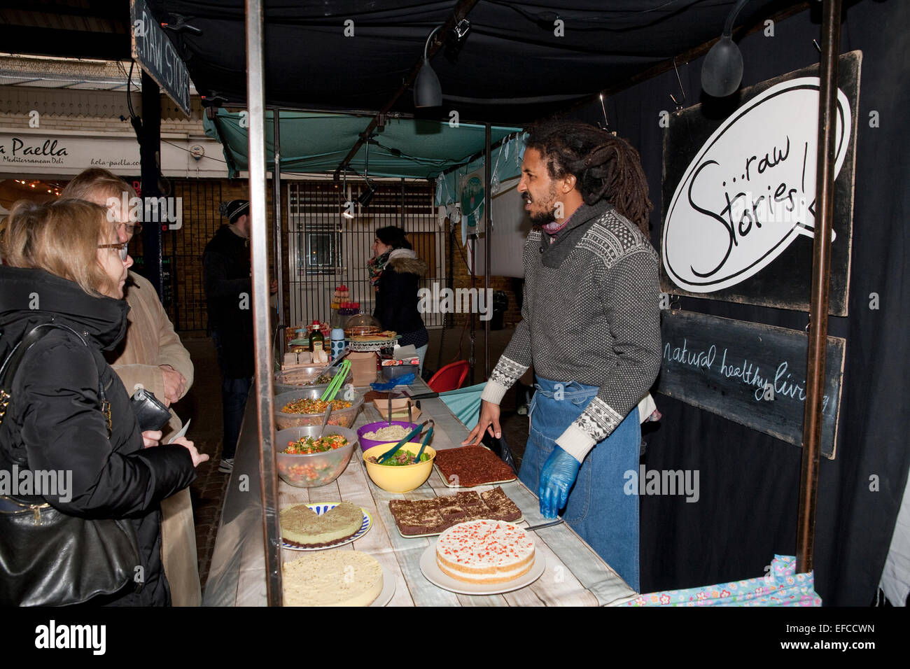 Visitors chat to a natural healthy living stall holder at the world ...