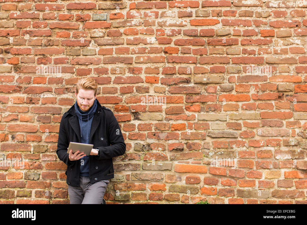 Red brick wall man standing hi-res stock photography and images - Alamy