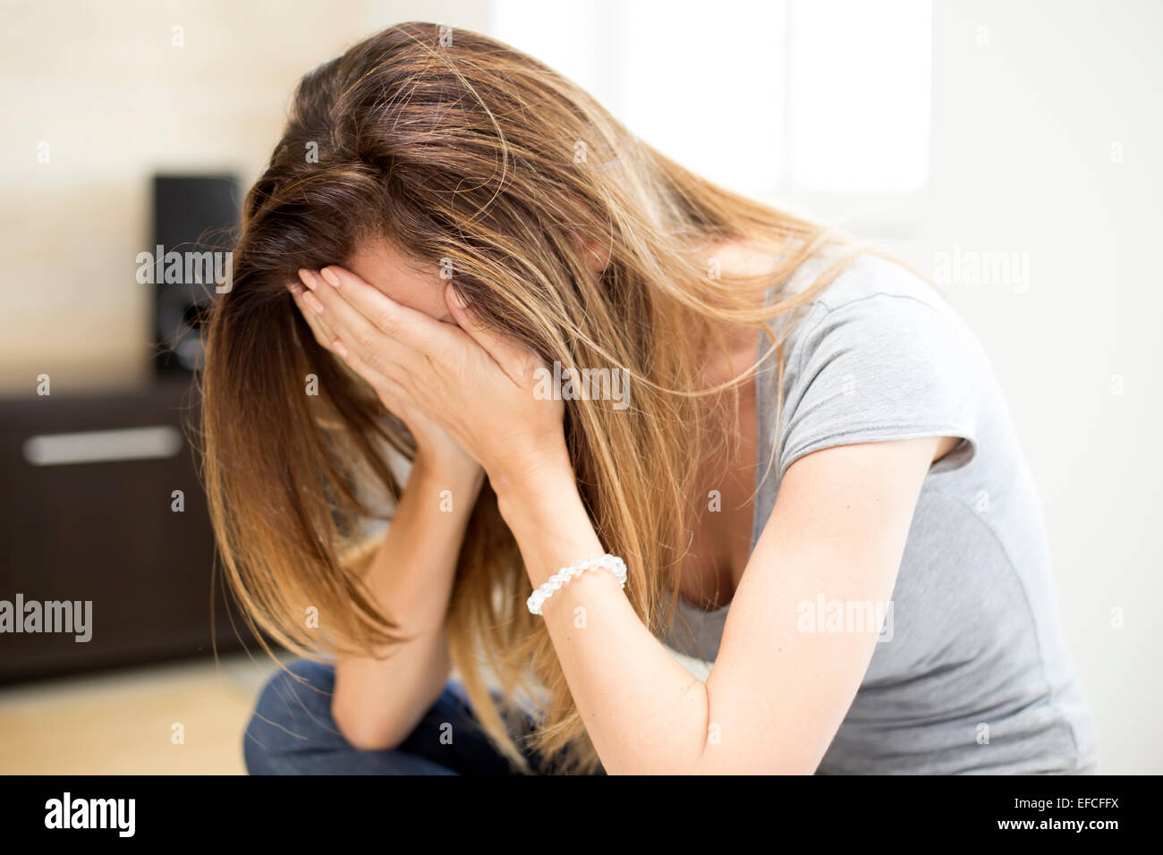Sad woman in the room Stock Photo - Alamy