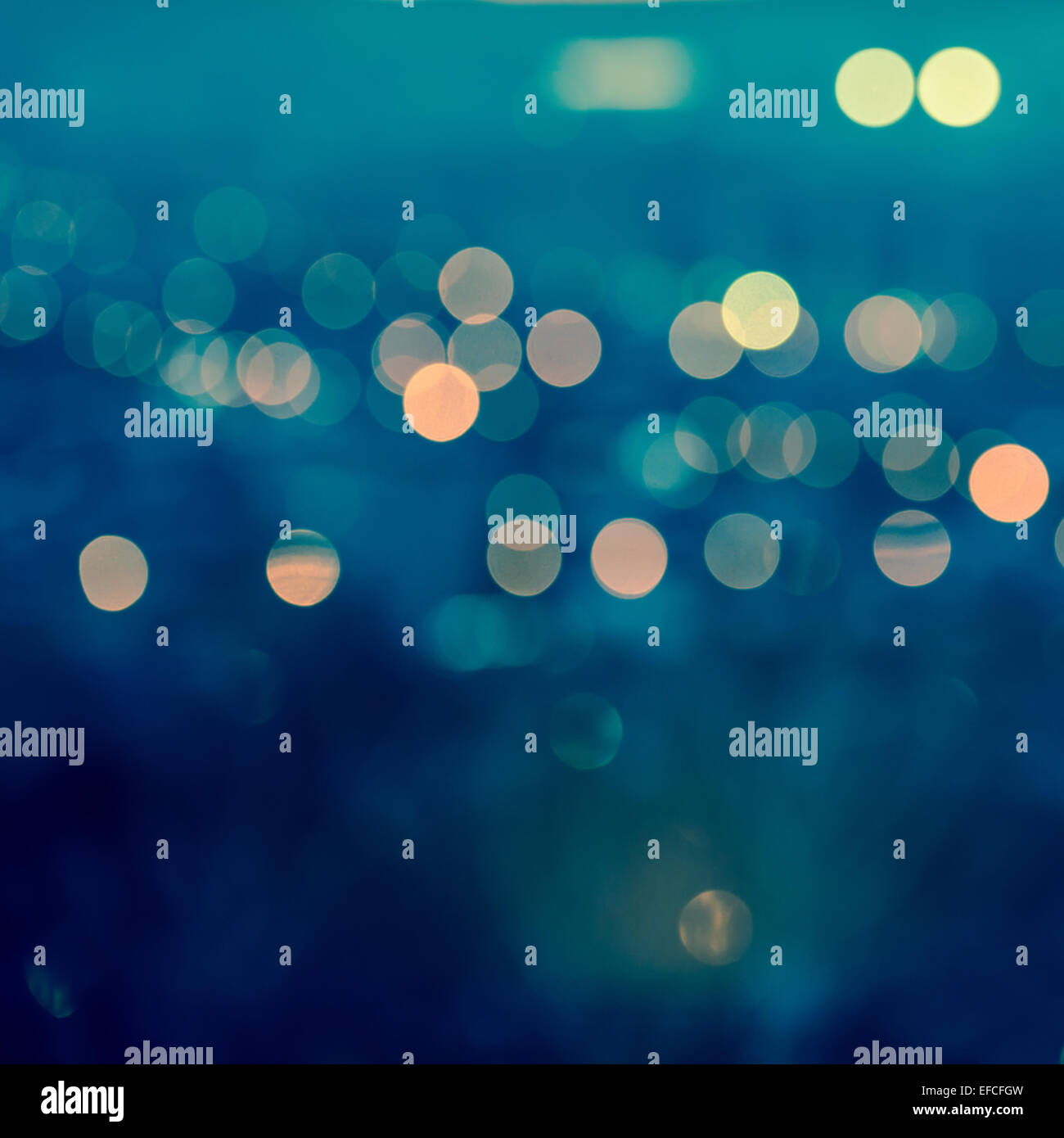 city blurring lights abstract circular bokeh on toned blue background ...