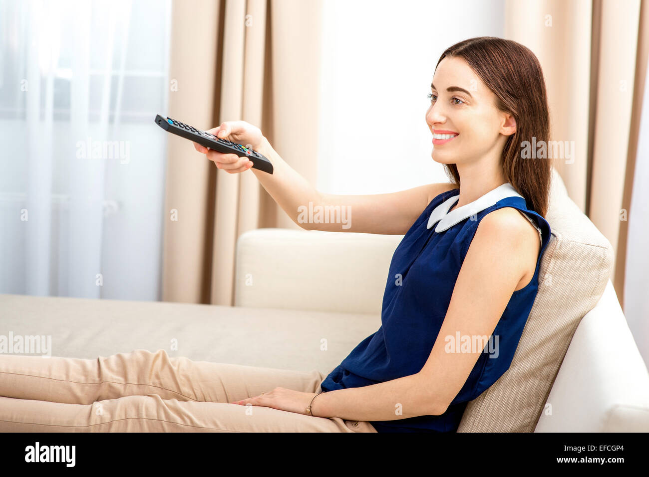 Woman watching TV Stock Photo - Alamy