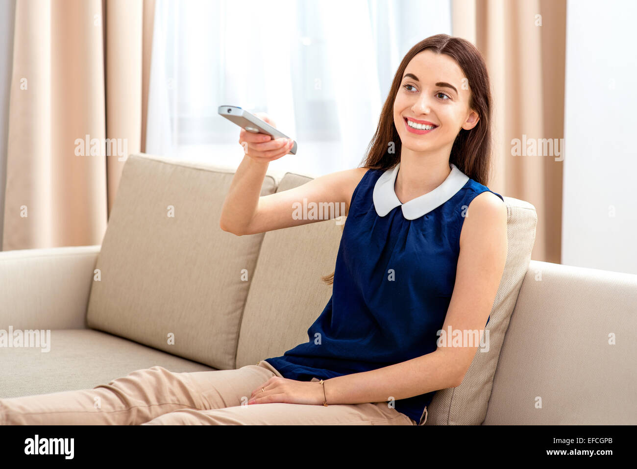 Woman watching TV Stock Photo - Alamy