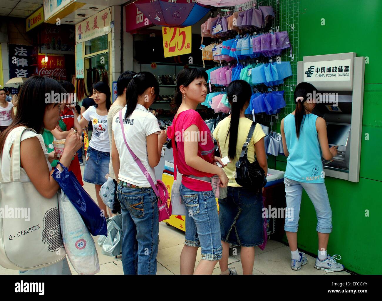 Chengdu, China: A queue of women waiting to use an outdoor China Postal ...
