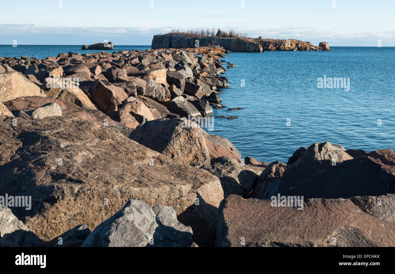 Rocks by lake shore Stock Photo - Alamy