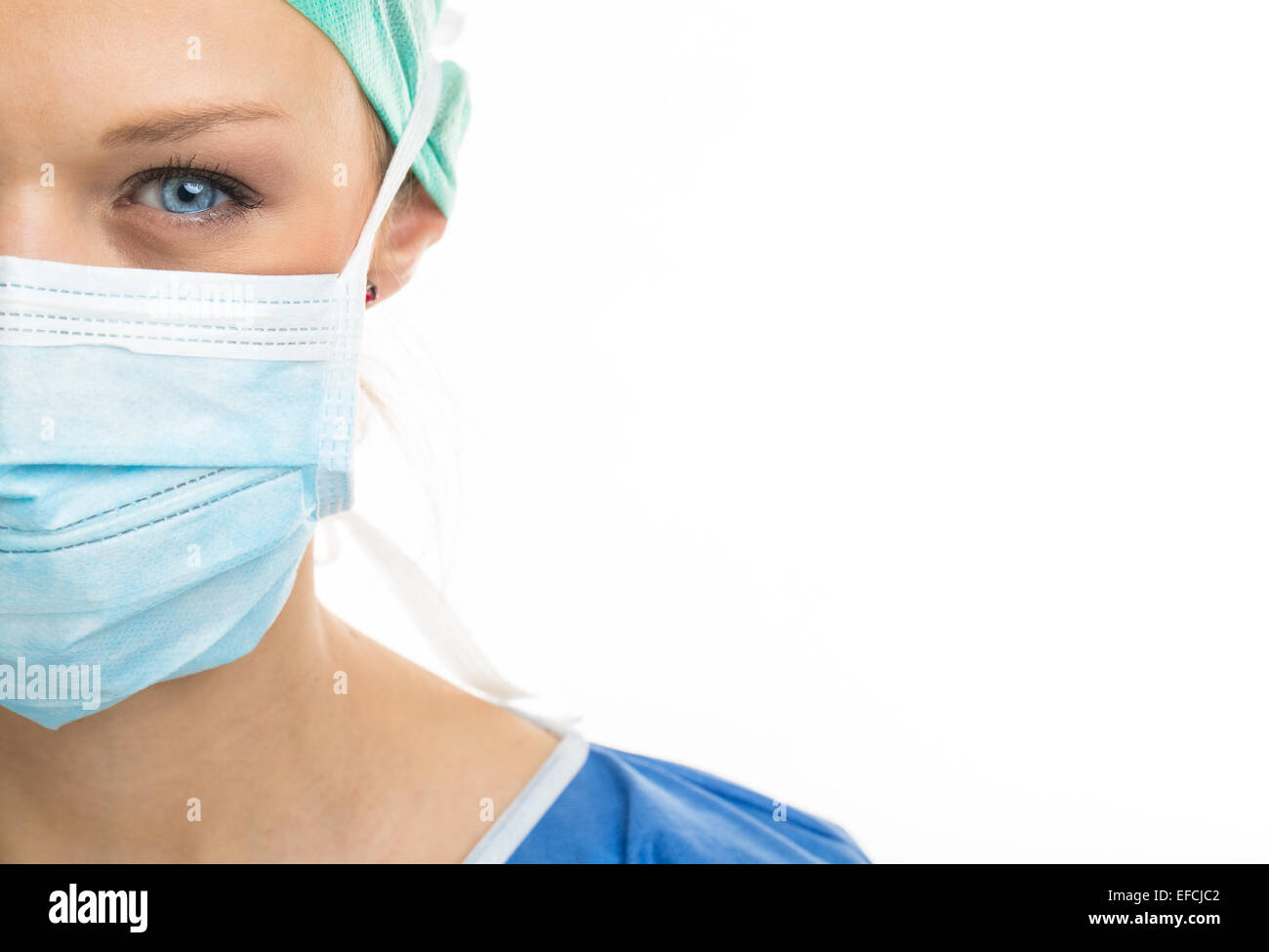 Close up of a pretty, blue-eyed, female surgeon. Half face composition ...