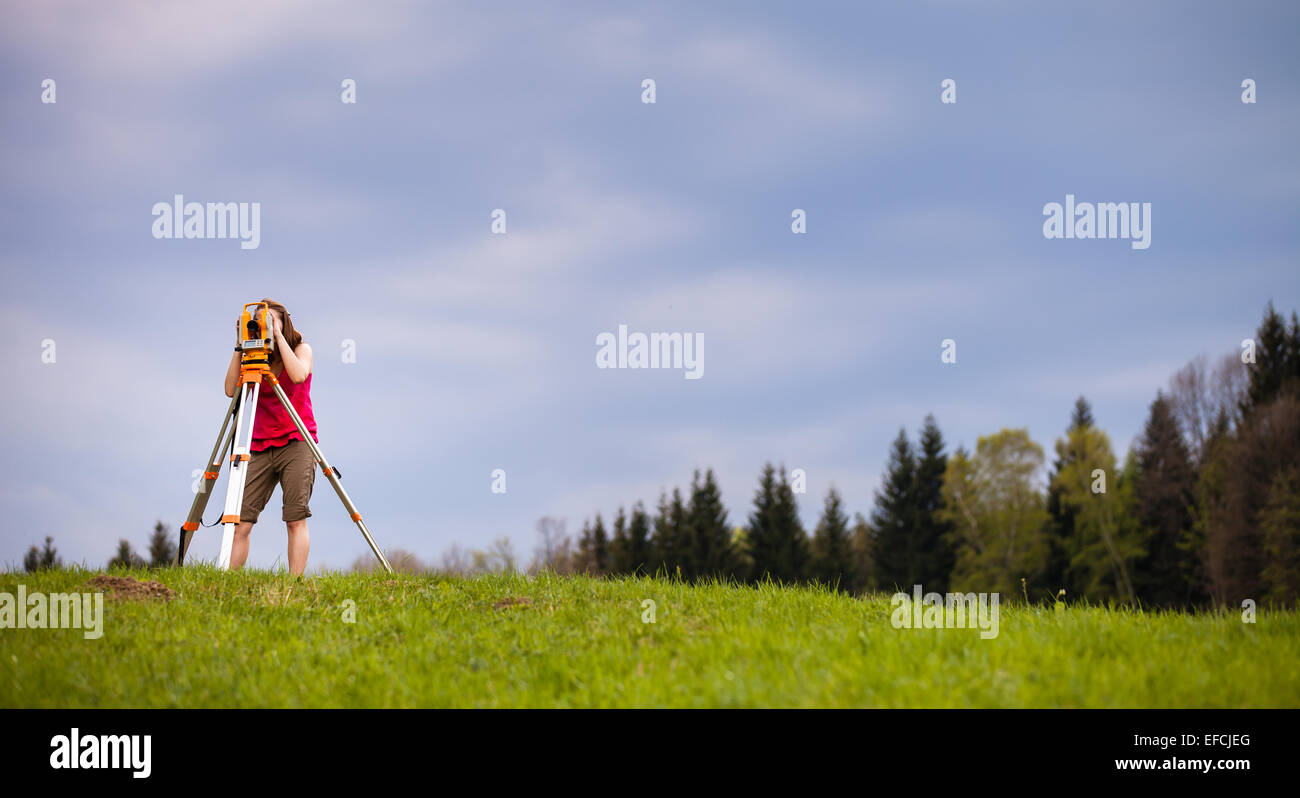 Young land surveyor at work Stock Photo - Alamy