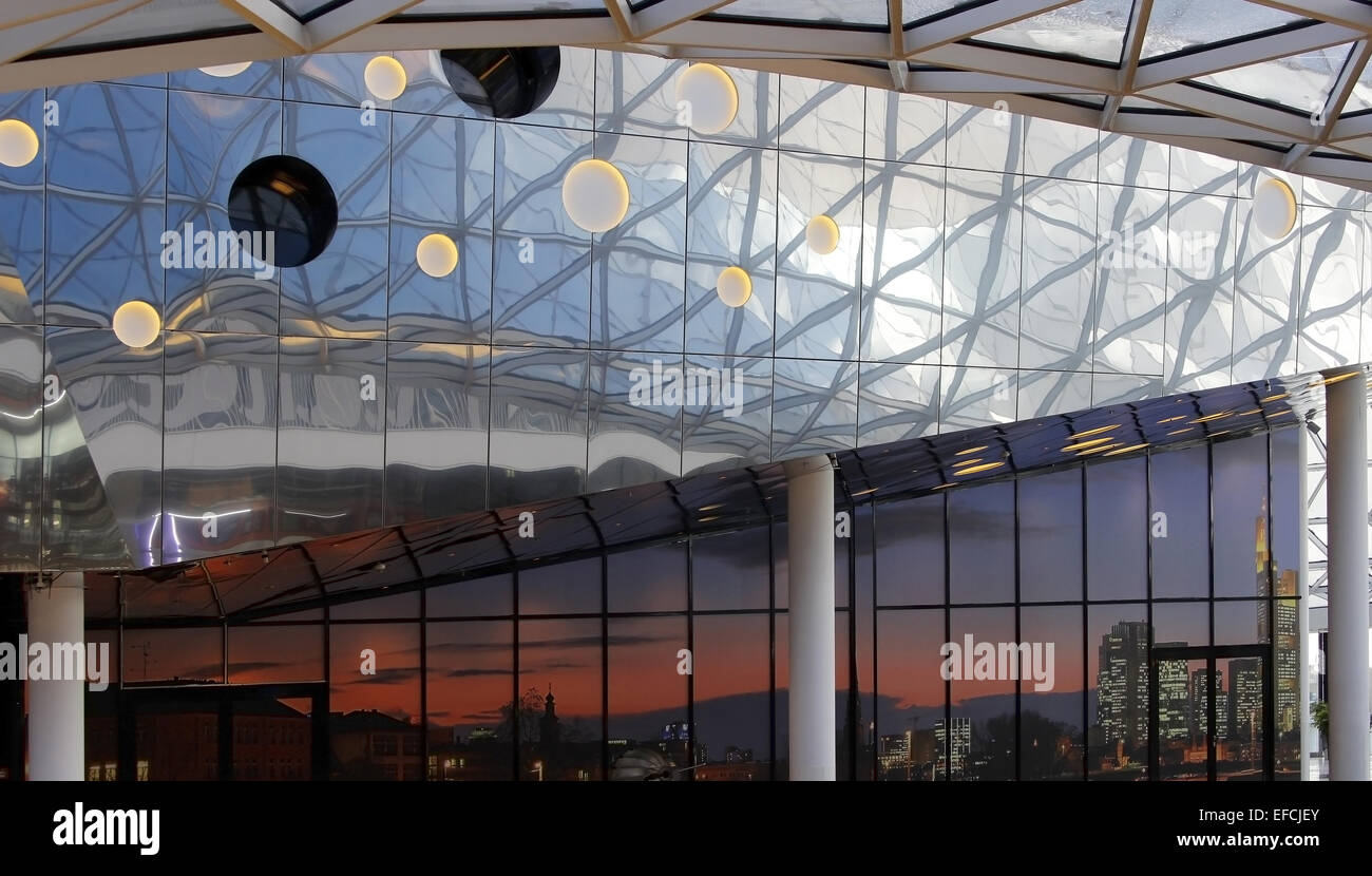 Frankfurt skyline at sunset through shopping mall's transparent wall ...