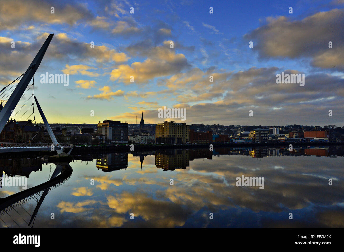 Peace Bridge and waterfront buildings reflection on River Foyle ...