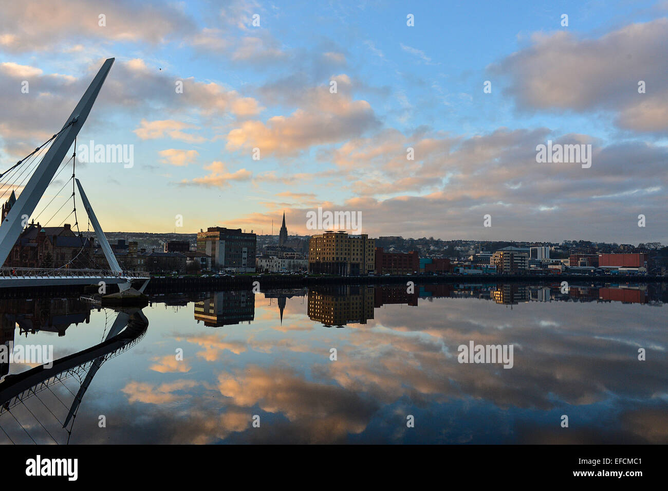 Peace Bridge and waterfront buildings reflection on River Foyle ...