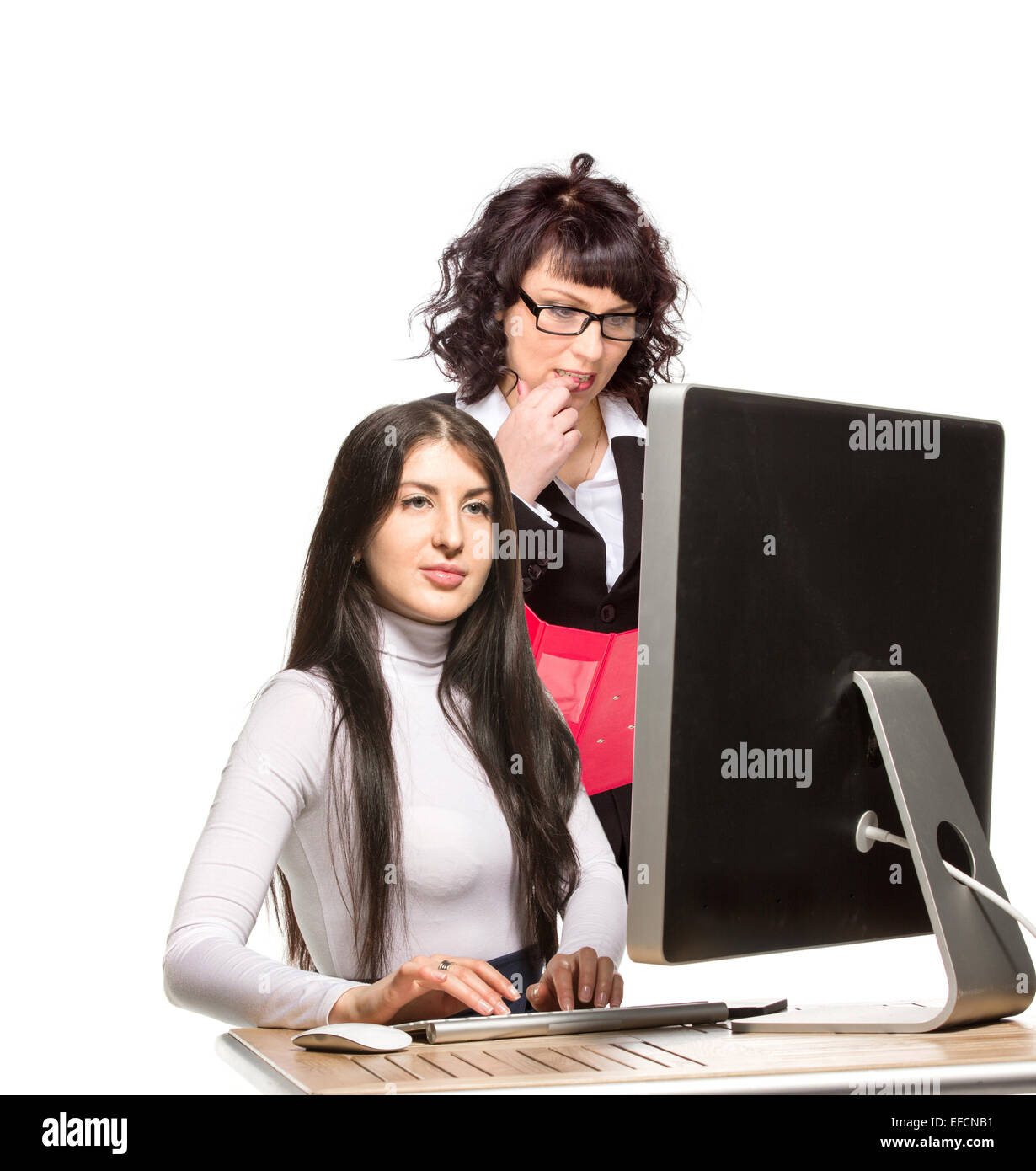 Two business woman in front of computer, isolated Stock Photo - Alamy