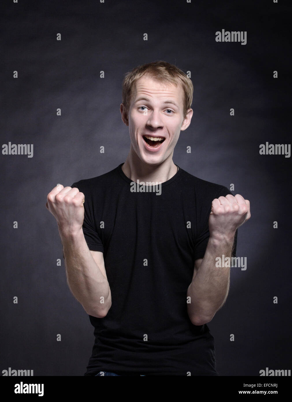 man winner pose on black background Stock Photo - Alamy