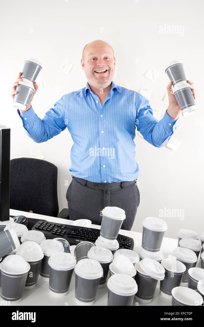 Happy businessman addicted to coffee Stock Photo - Alamy