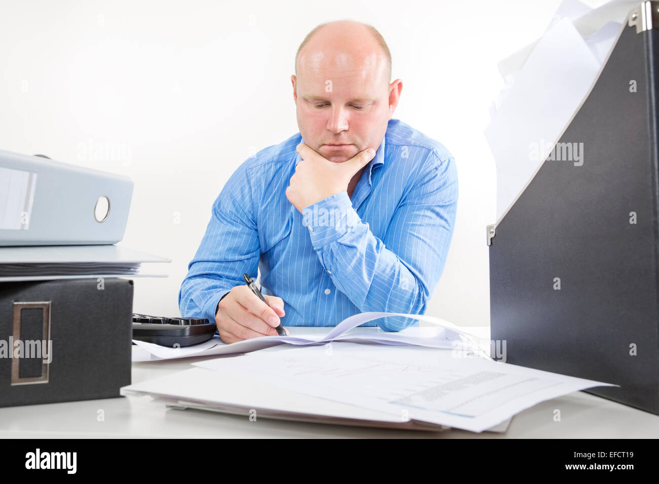 Overworked businessman at the office Stock Photo - Alamy