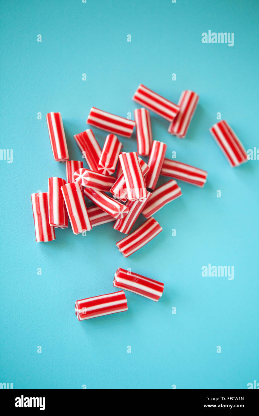 red and white striped candies on blue Stock Photo - Alamy